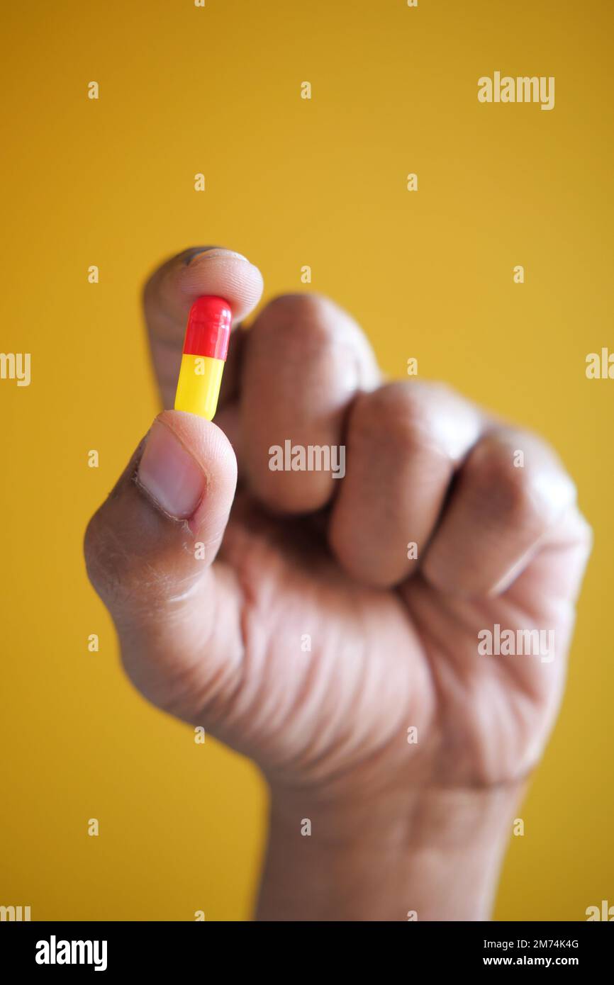 men holding a single capsule Stock Photo - Alamy