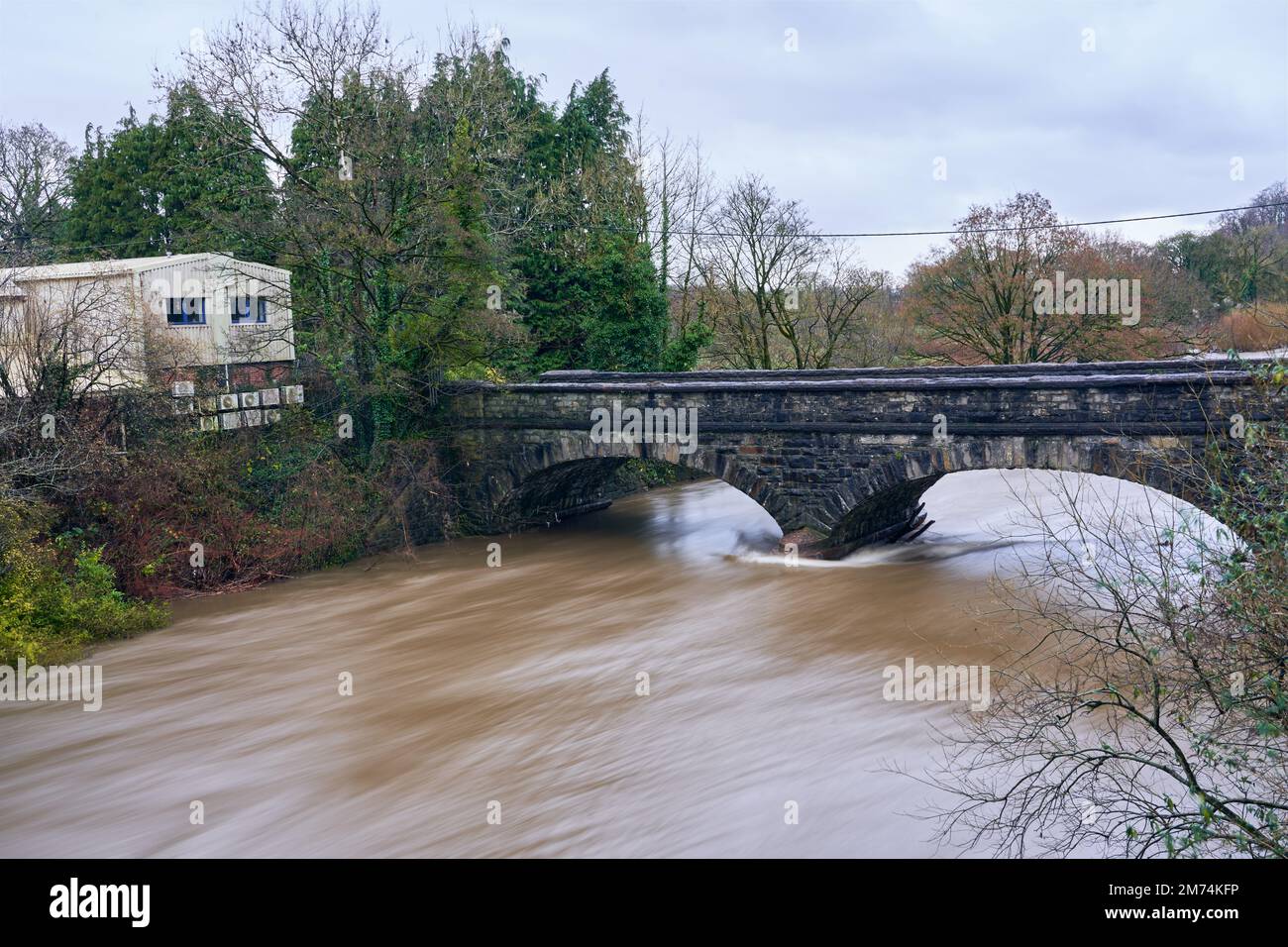 The Ynys Bridge over a full River Taff after heavy rain in South Wales ...