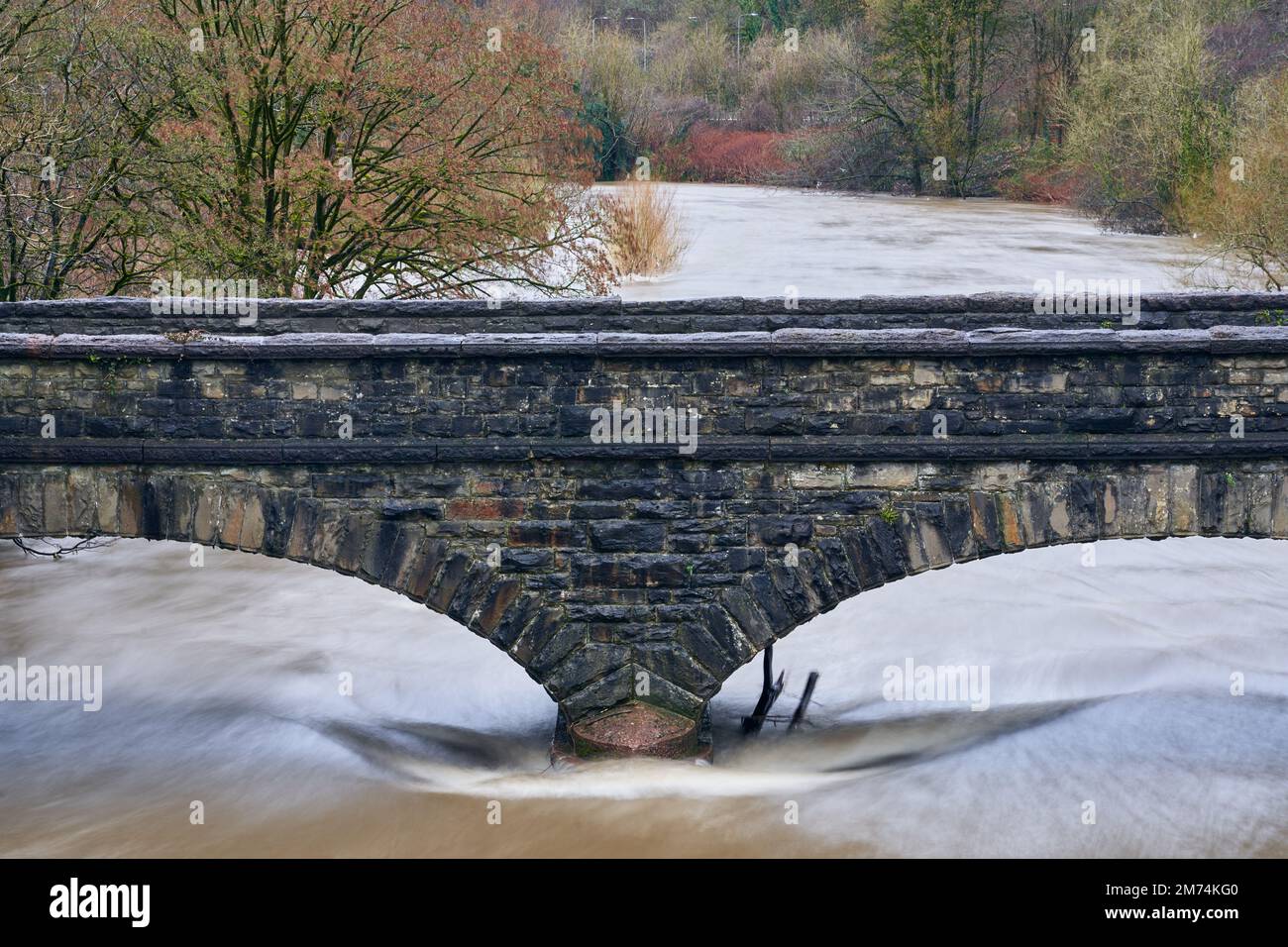 The Ynys Bridge over a full River Taff after heavy rain in South Wales ...