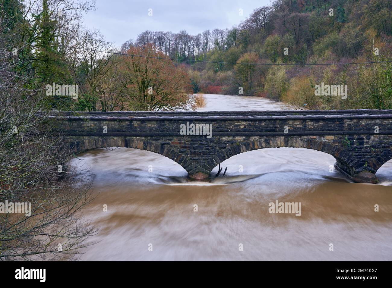 The Ynys Bridge over a full River Taff after heavy rain in South Wales ...