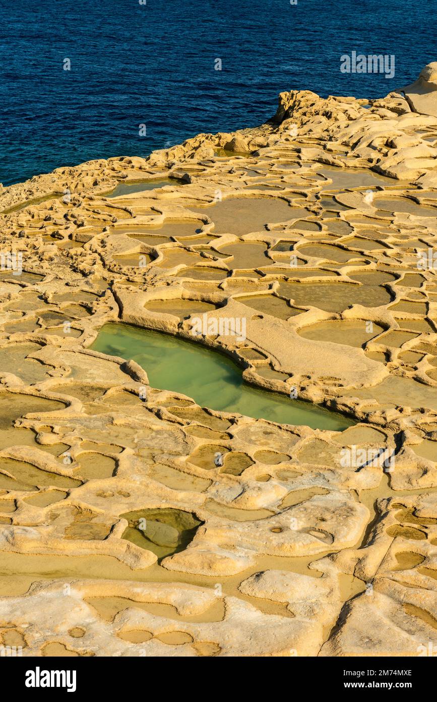 Xwejni Bay, Malta traditional salt pans on the beach of island of Gozo ...