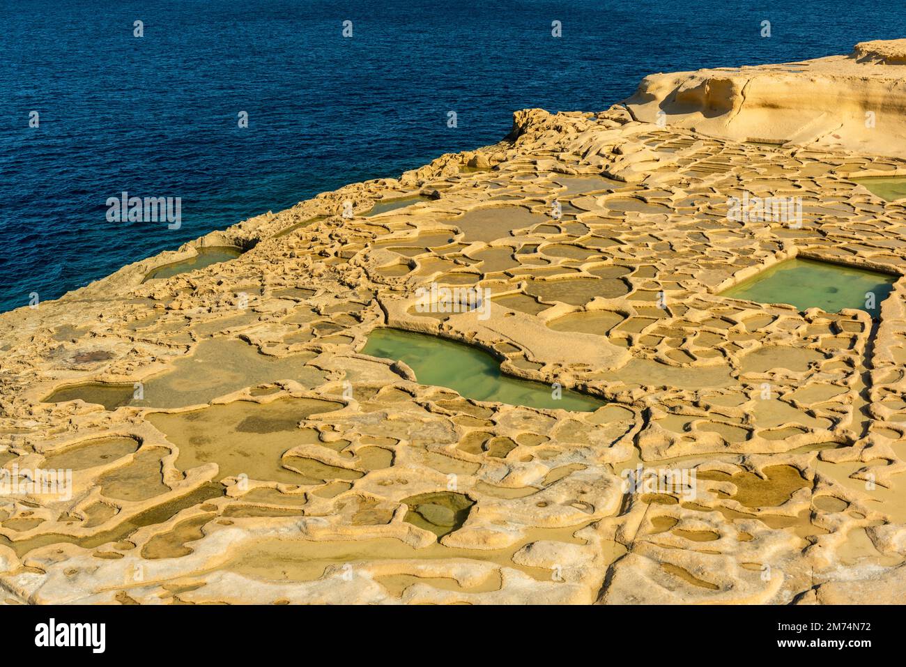 Xwejni Bay, Malta traditional salt pans on the beach of island of Gozo ...