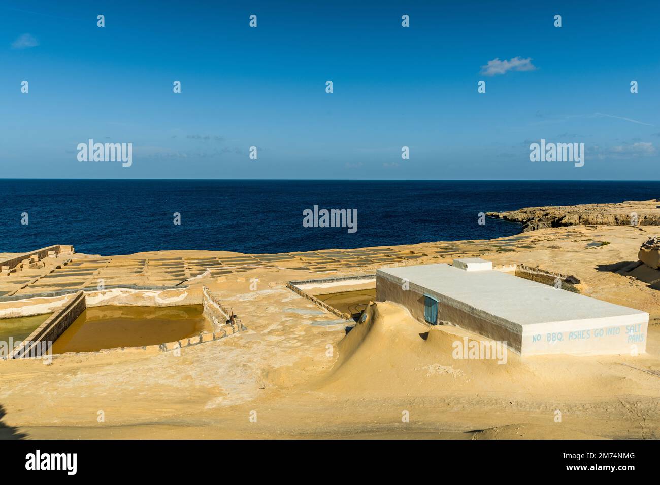Salt pans in Xwejni Bay beach on the island of Gozo, Malta. Traditional ...