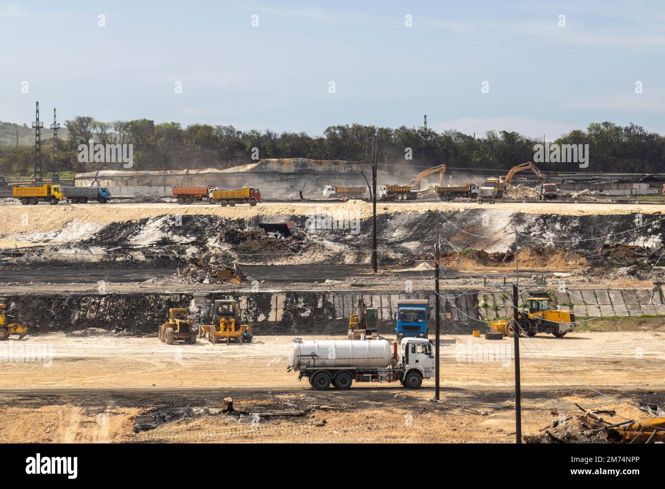 A group of construction trucks working at the site Stock Photo - Alamy