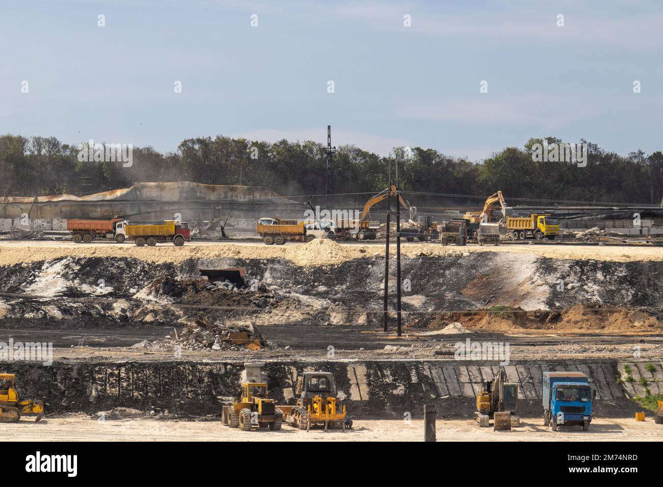 A group of construction trucks working at the site Stock Photo - Alamy