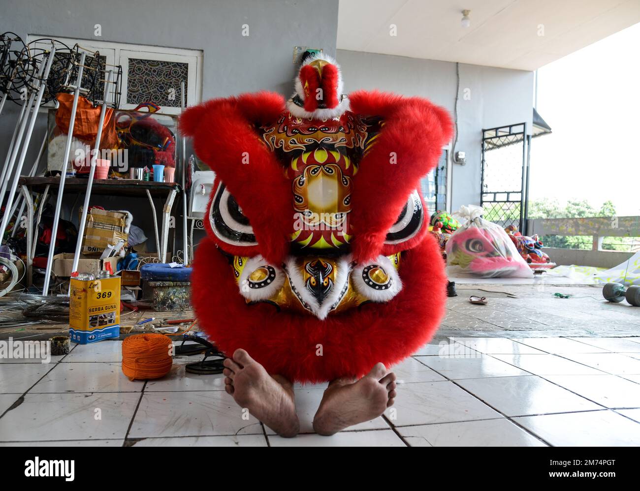 A Indonesian craftsman create parts of a lion dance costume ahead of ...