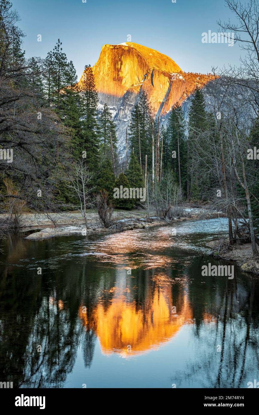 Photo of Half-Dome right at sunset bathed in golden light and reflected ...