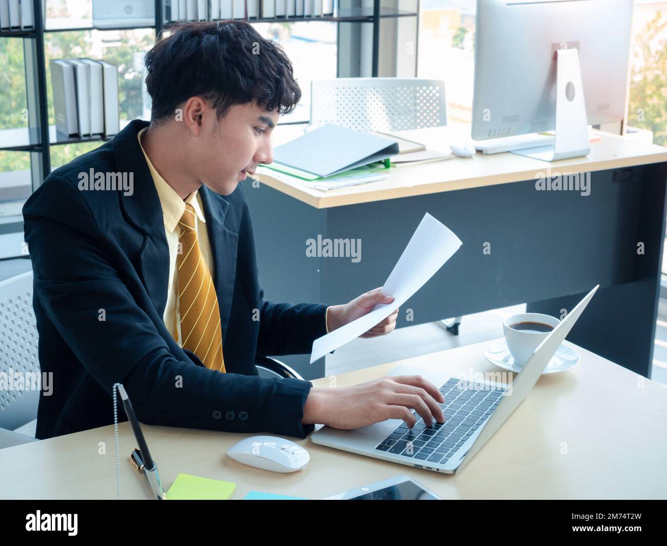 Young business people are concentrating on their work by comparing the ...