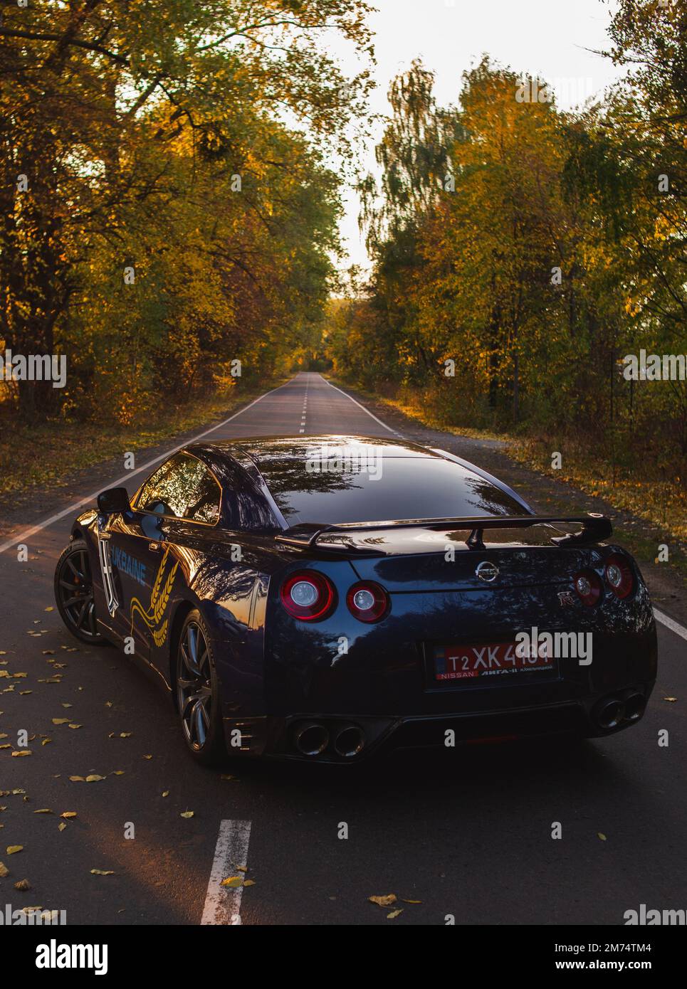 A vertical shot of a Nissan Gtr r35 parked on a highway Stock Photo - Alamy