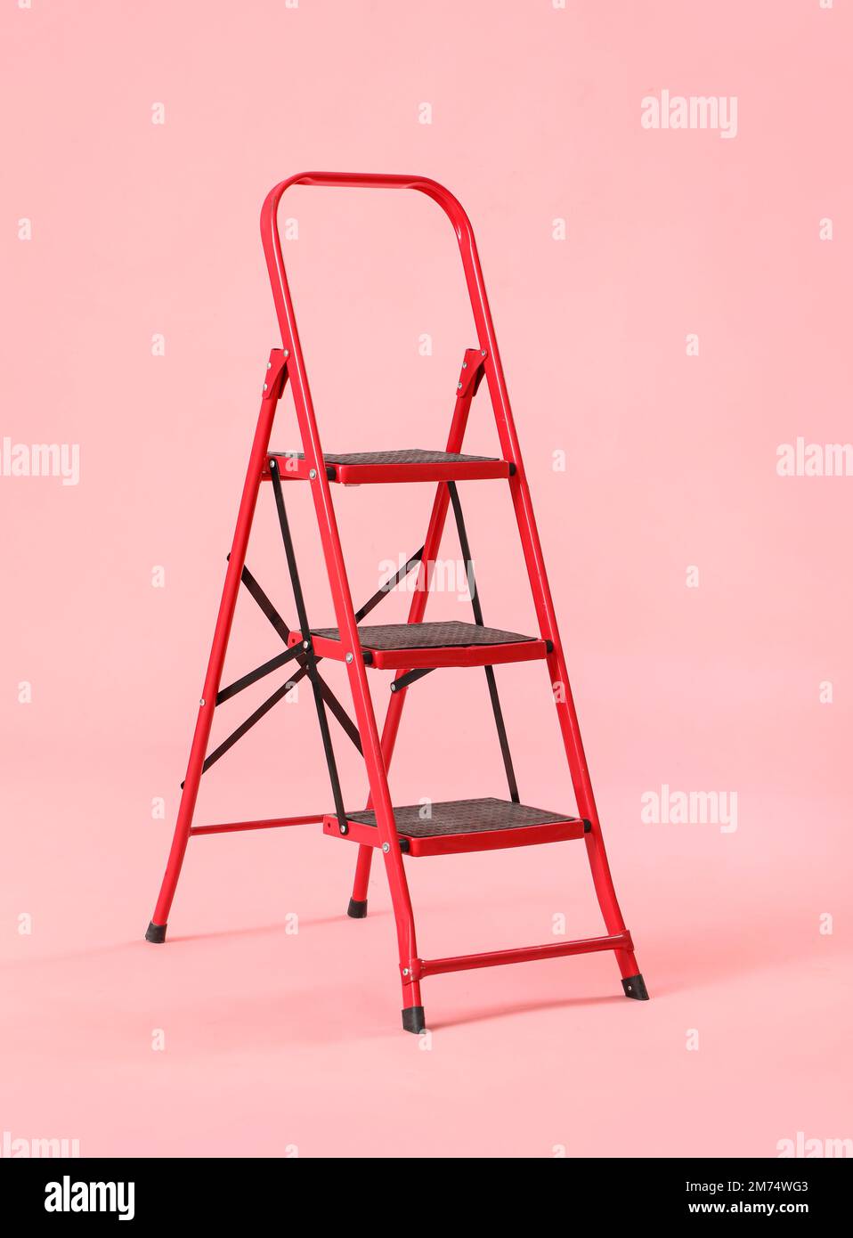 Maintenance ladder on pink background Stock Photo - Alamy