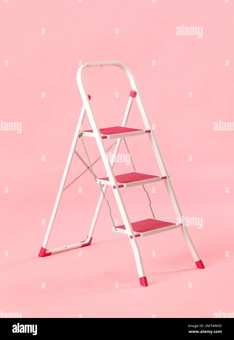 Maintenance ladder on pink background Stock Photo - Alamy