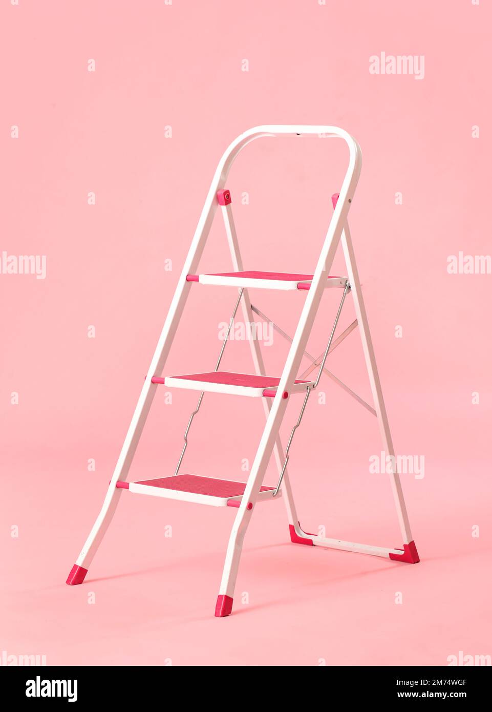 Maintenance ladder on pink background Stock Photo - Alamy