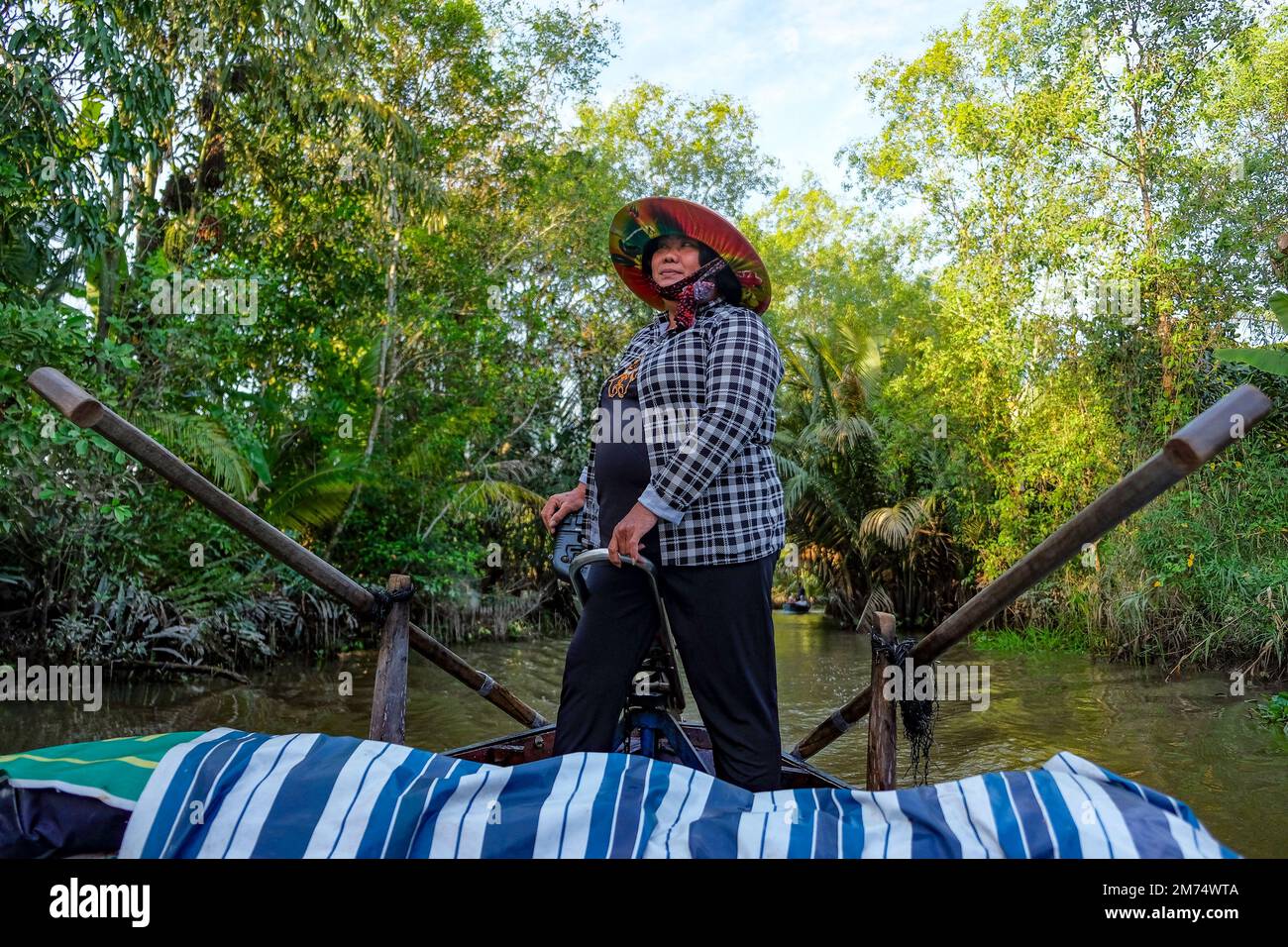 Can Tho, Vietnam - January 4, 2023: A woman sailing a boat in the Mekong River Delta in Can Tho ...