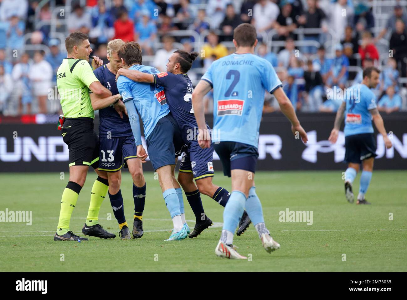 Nicholas Pennington of Wellington and Max Burgess of Sydney FC clash ...