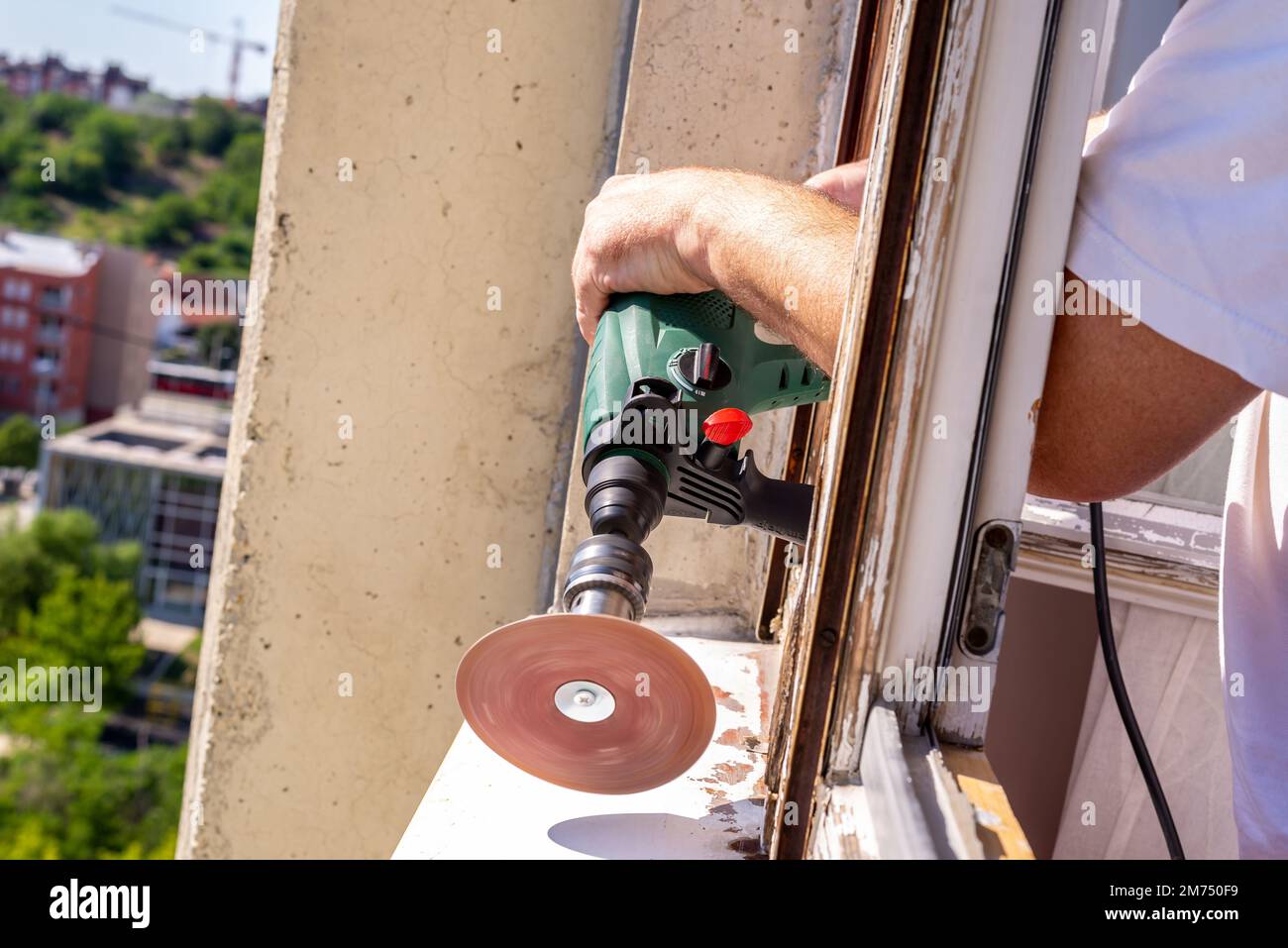 Sanding rust from an old window cill - preparing a machine Stock Photo ...