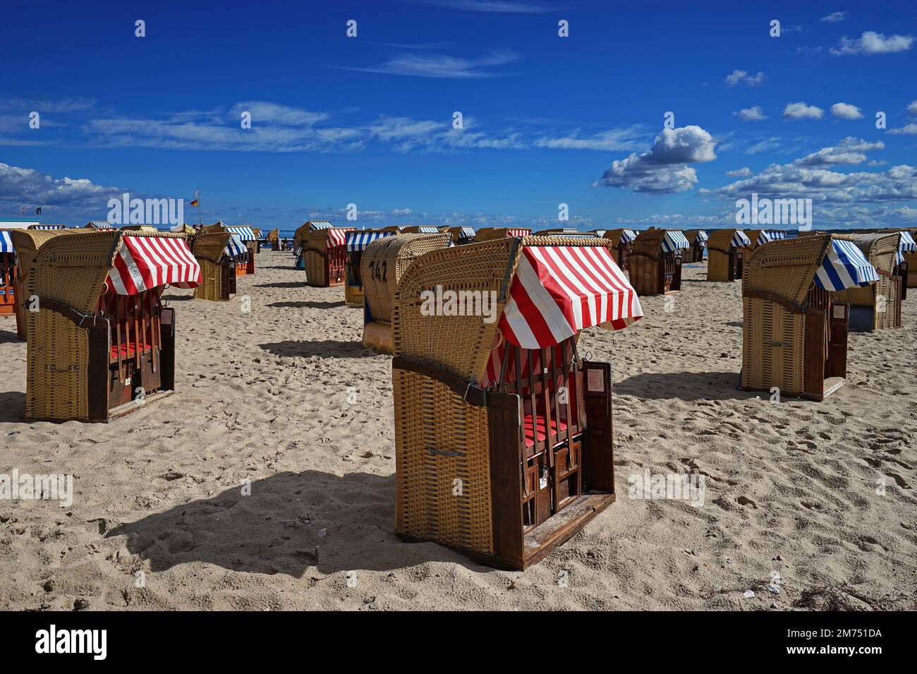 The bench-cabins on the sandy beach in Travemuende alongside the Baltic ...
