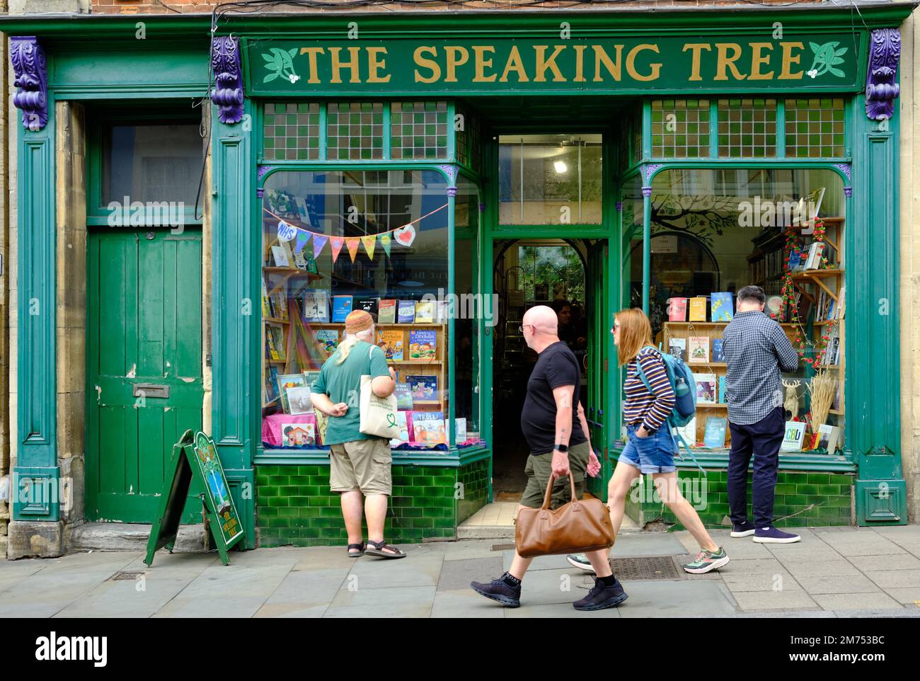 Visitors and window shoppers in front of The Speaking Tree shop ...