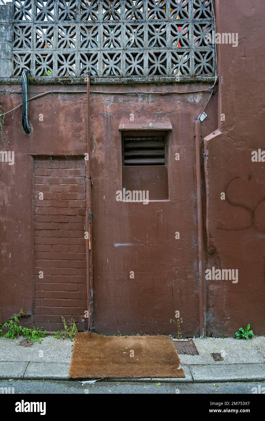 Brown painted building exterior wall with bricked up doorway Stock ...