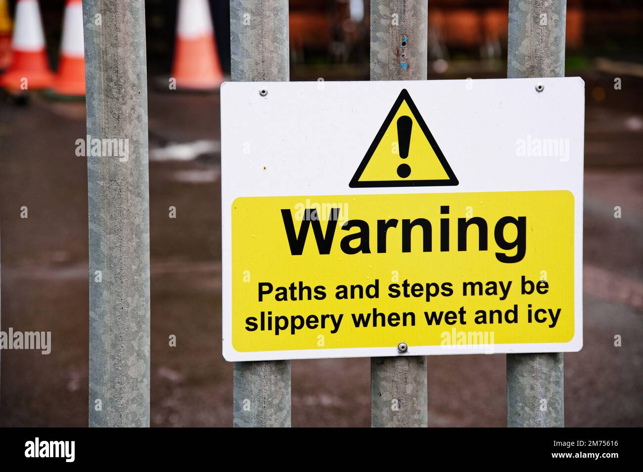 Slippery when wet and icy warning sign at entrance to building site ...