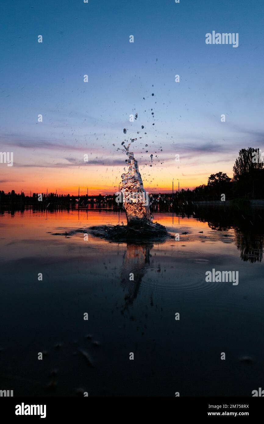 Splash on a lake water at the sunset time. At the summertime ...
