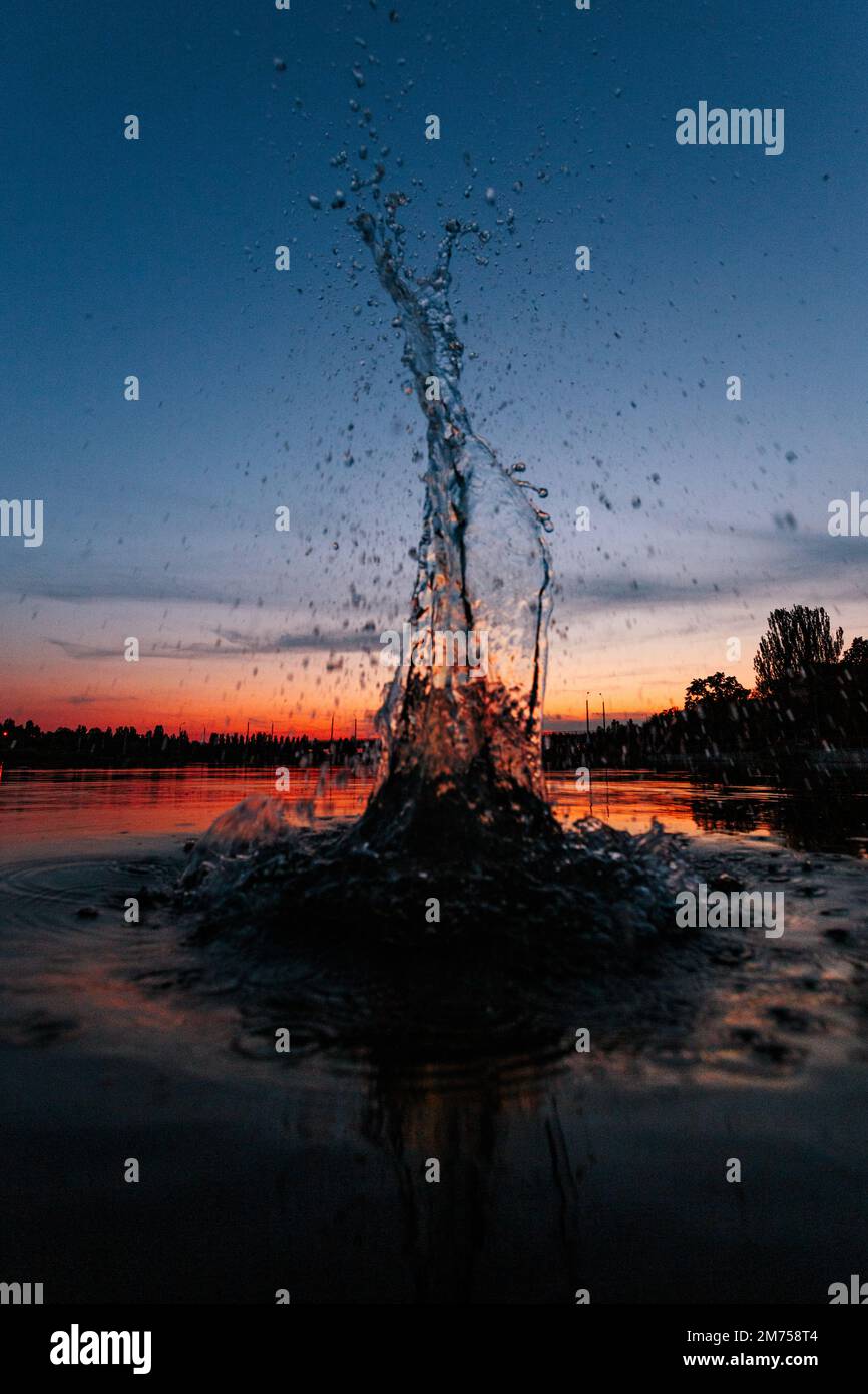 Splash on a lake water at the sunset time. At the summertime ...