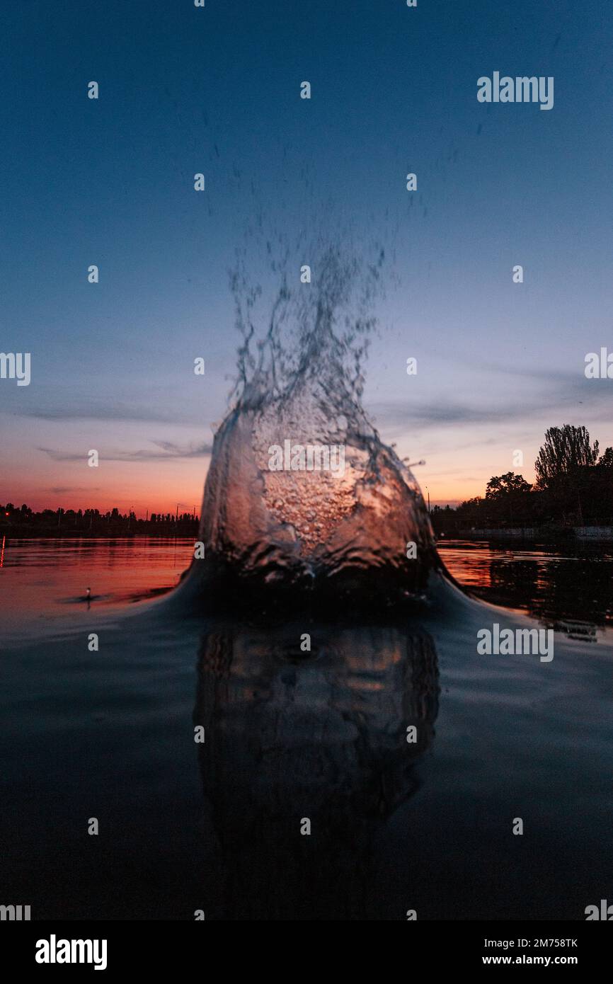 Splash on a lake water at the sunset time. At the summertime ...