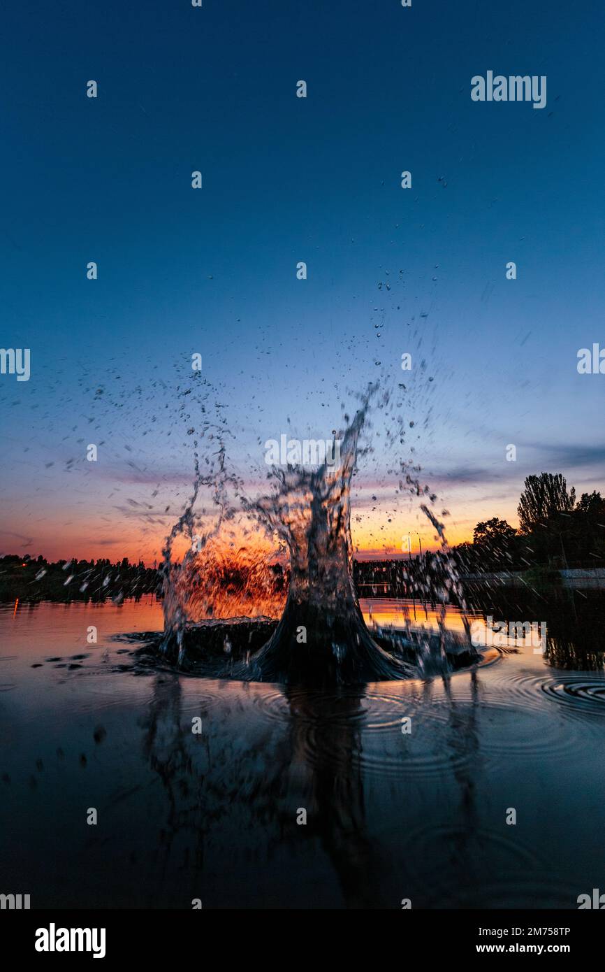 Splash on a lake water at the sunset time. At the summertime ...