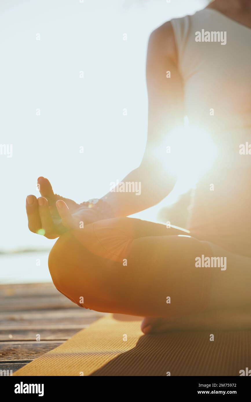 Close-up of a yogi woman sitting in a lotus pose and meditating Stock ...