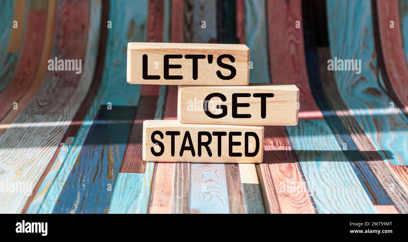 LET'S GET STARTED words on wooden building blocks on vintage background ...