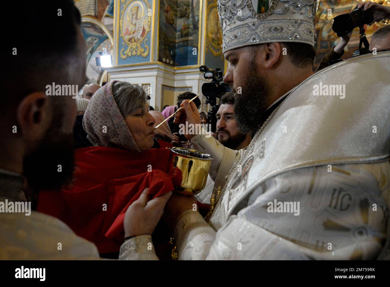 Kyiv, Ukraine. 7th Jan, 2023. A woman receives communion from a priest ...