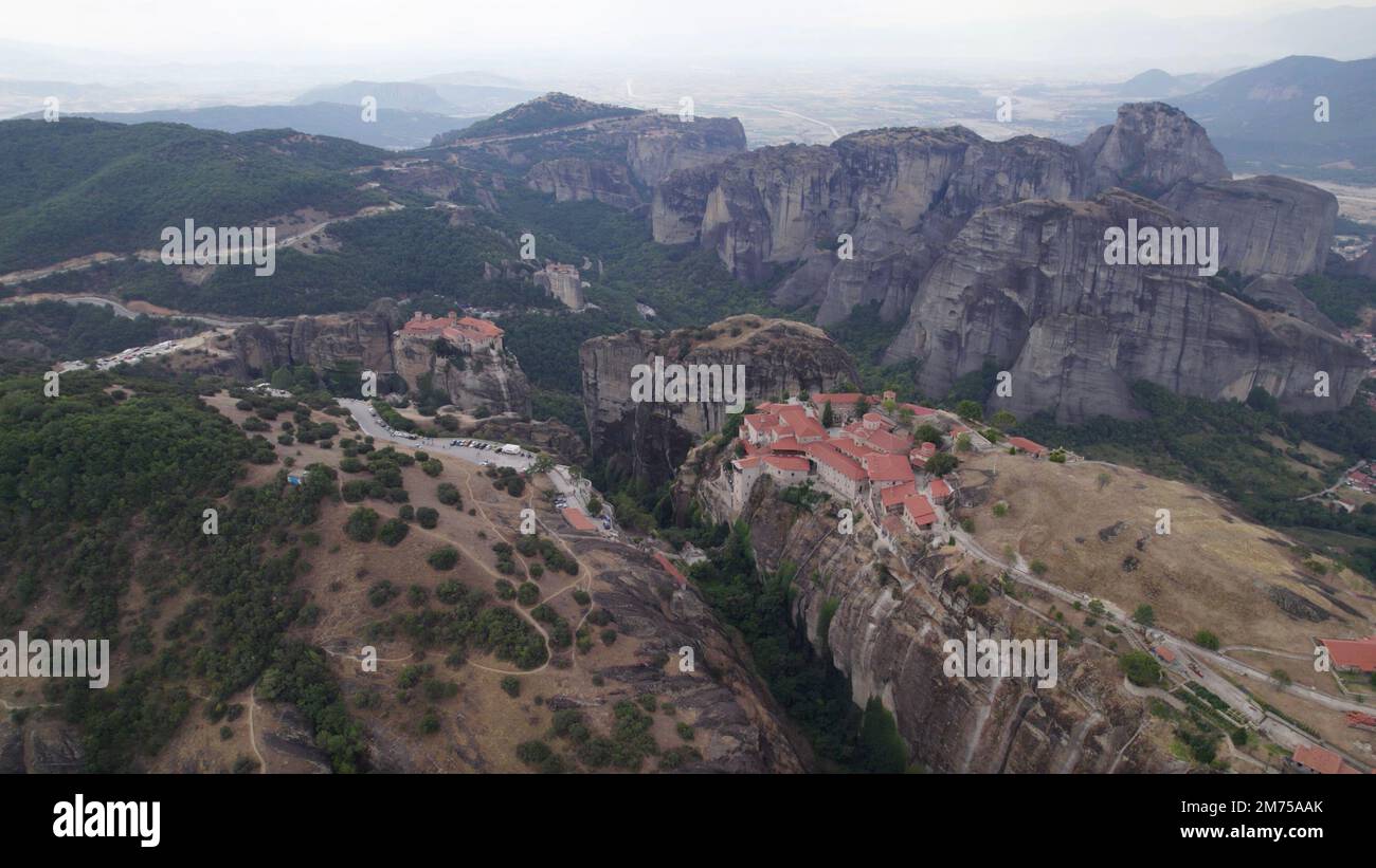 An aerial view of Meteora rock formations surrounded by buildings Stock ...