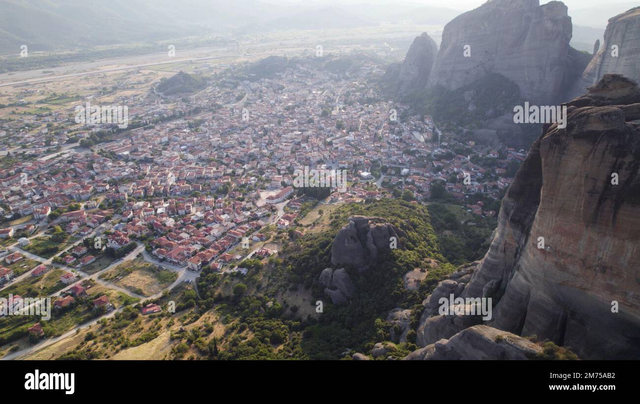 An aerial view of Meteora rock formations surrounded by buildings Stock ...