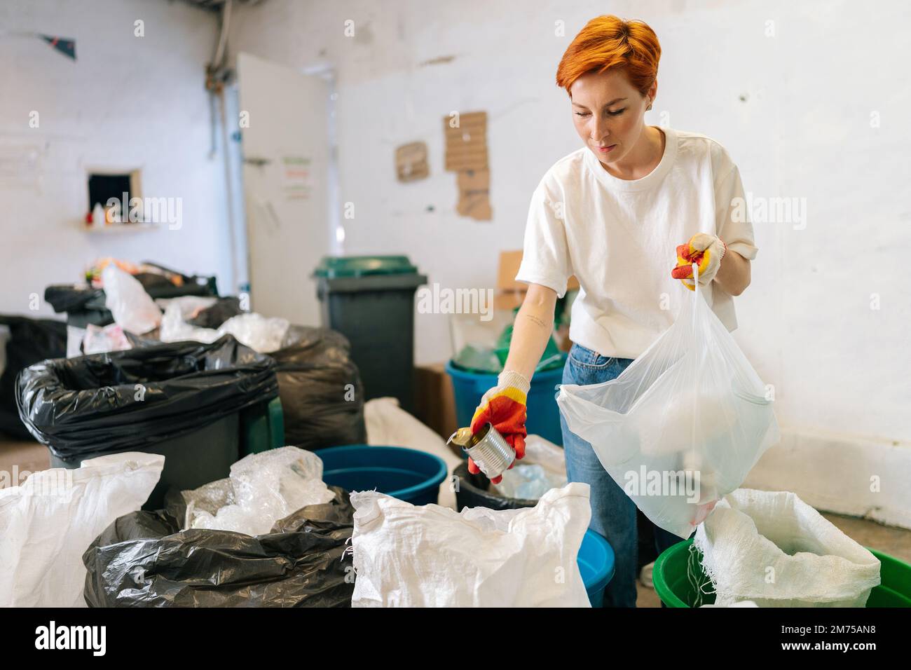 Portrait of professional female worker in latex gloves sorting diverse ...