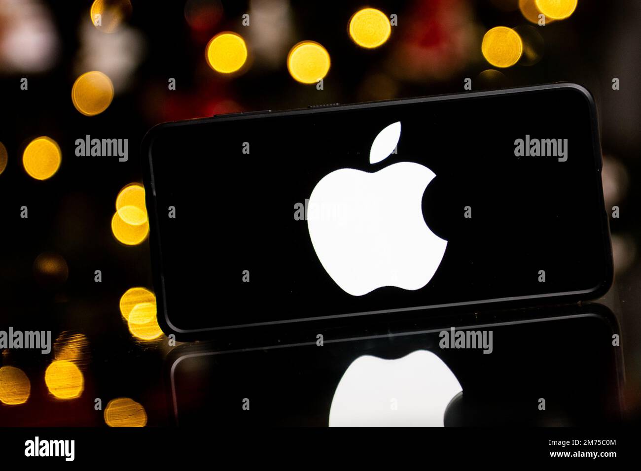 In this photo illustration an Apple logo seen displayed on a smartphone ...