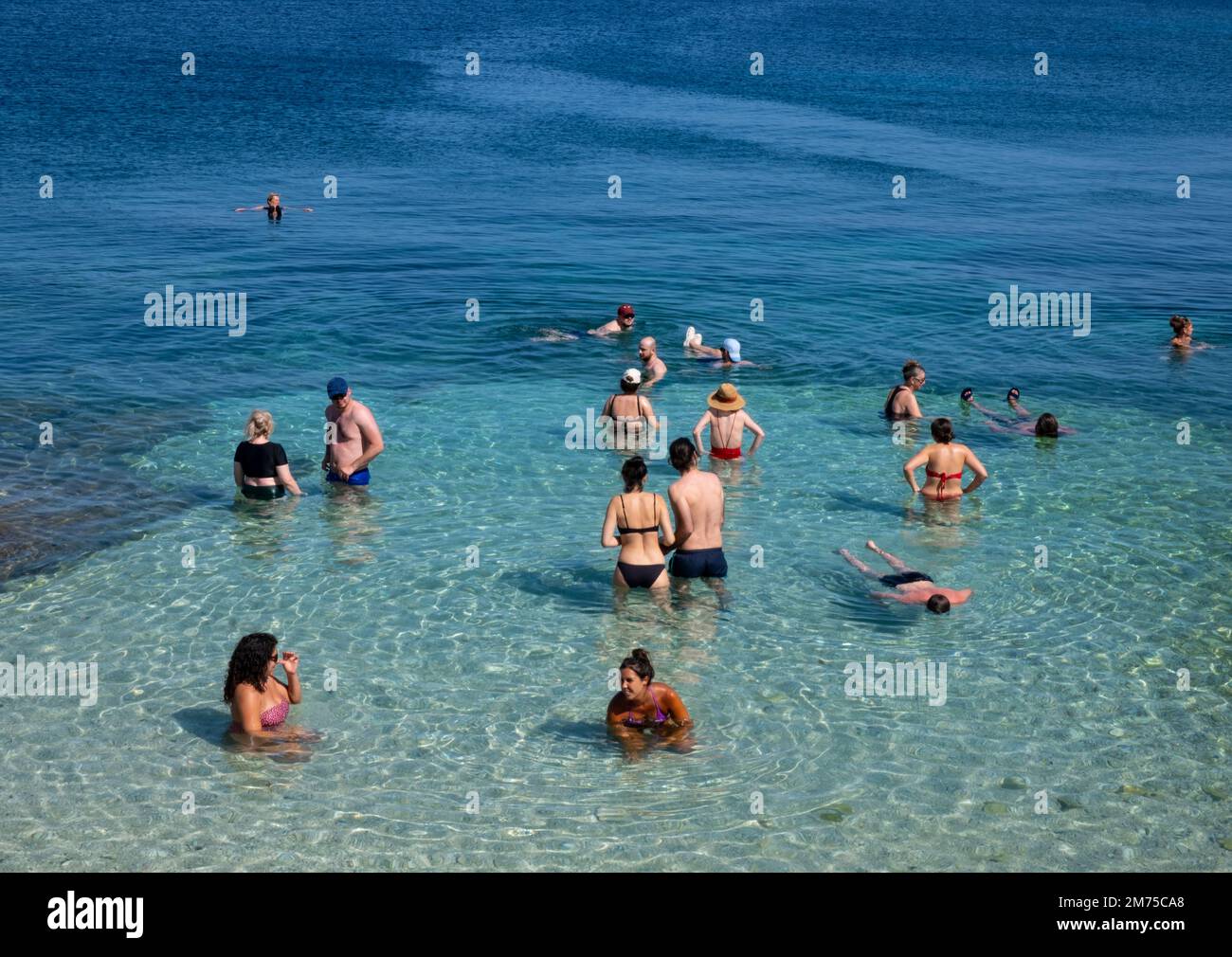 Bathers in a sandy spot of sea near Gaios, Paxos, Greece Stock Photo ...