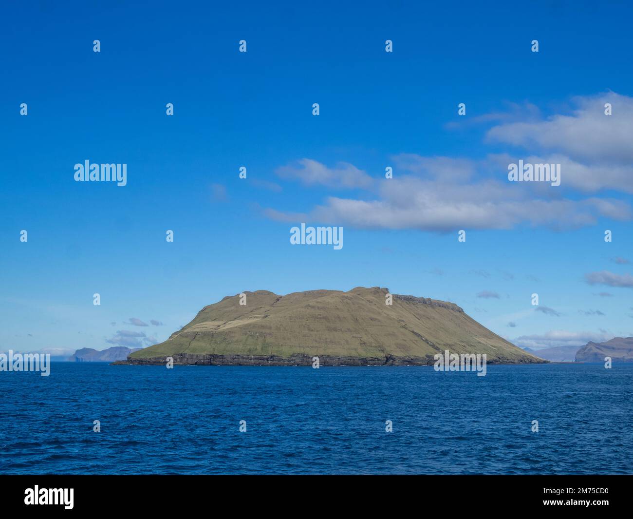 Hestur island flat top seen from Skopunarfjørður crossing Stock Photo ...
