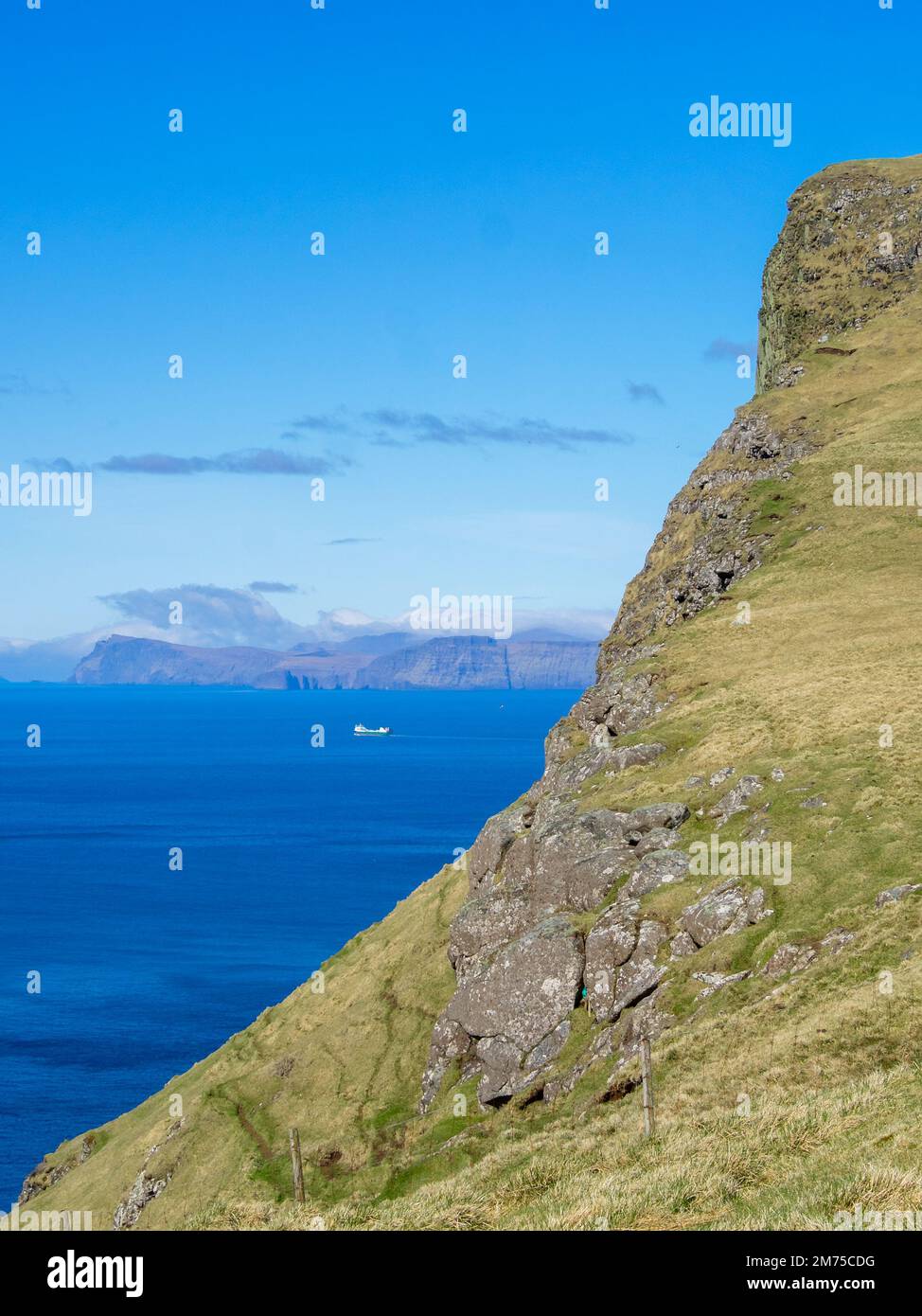 Djúpaberg cliff and Vágar island across the sea Stock Photo - Alamy