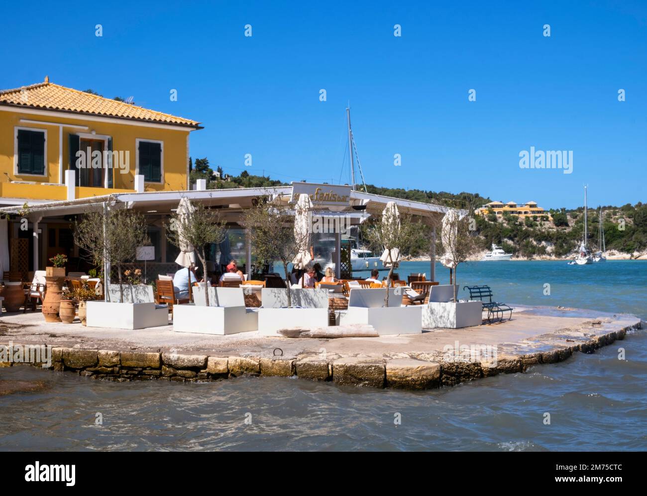 A bar protruding in the Lakka harbour on the island of Paxos, Greece ...