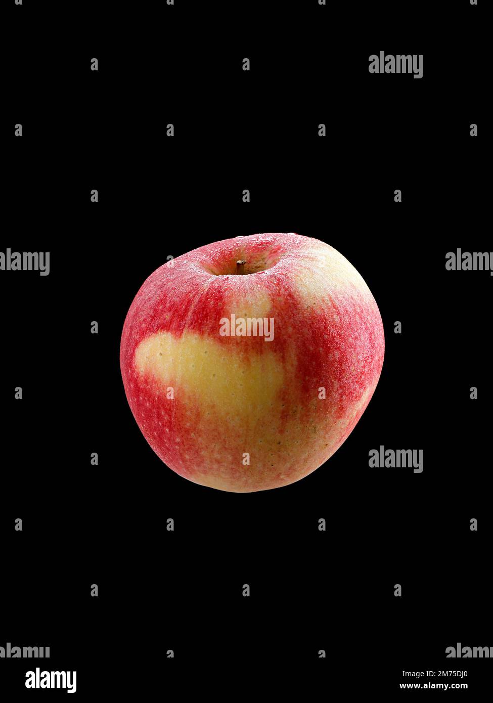 A vertical shot of a red apple isolated on a black background Stock ...