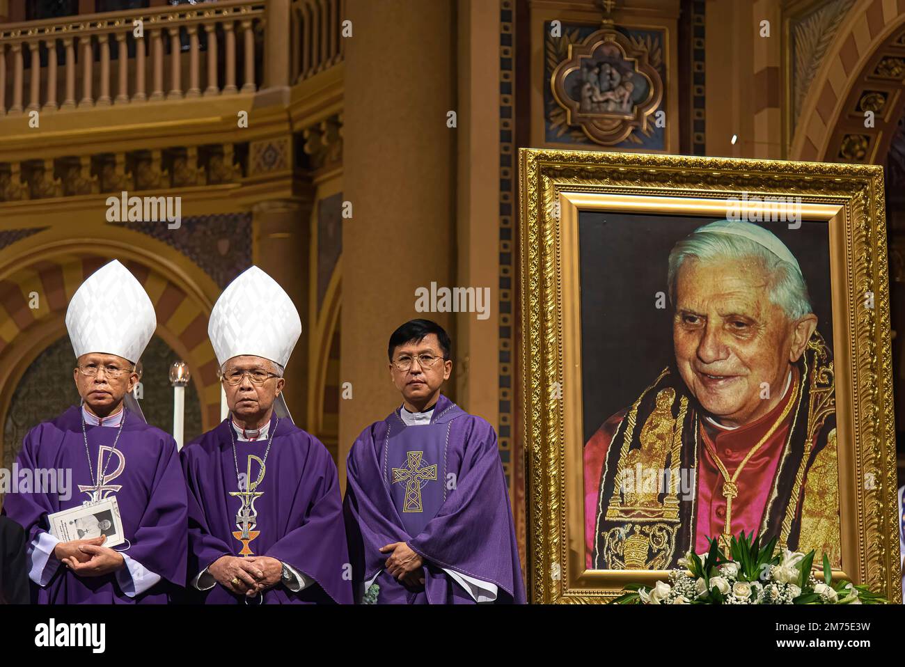 Thai Catholic priests seen standing next to the photo of the late pope during the Tribute to The ...