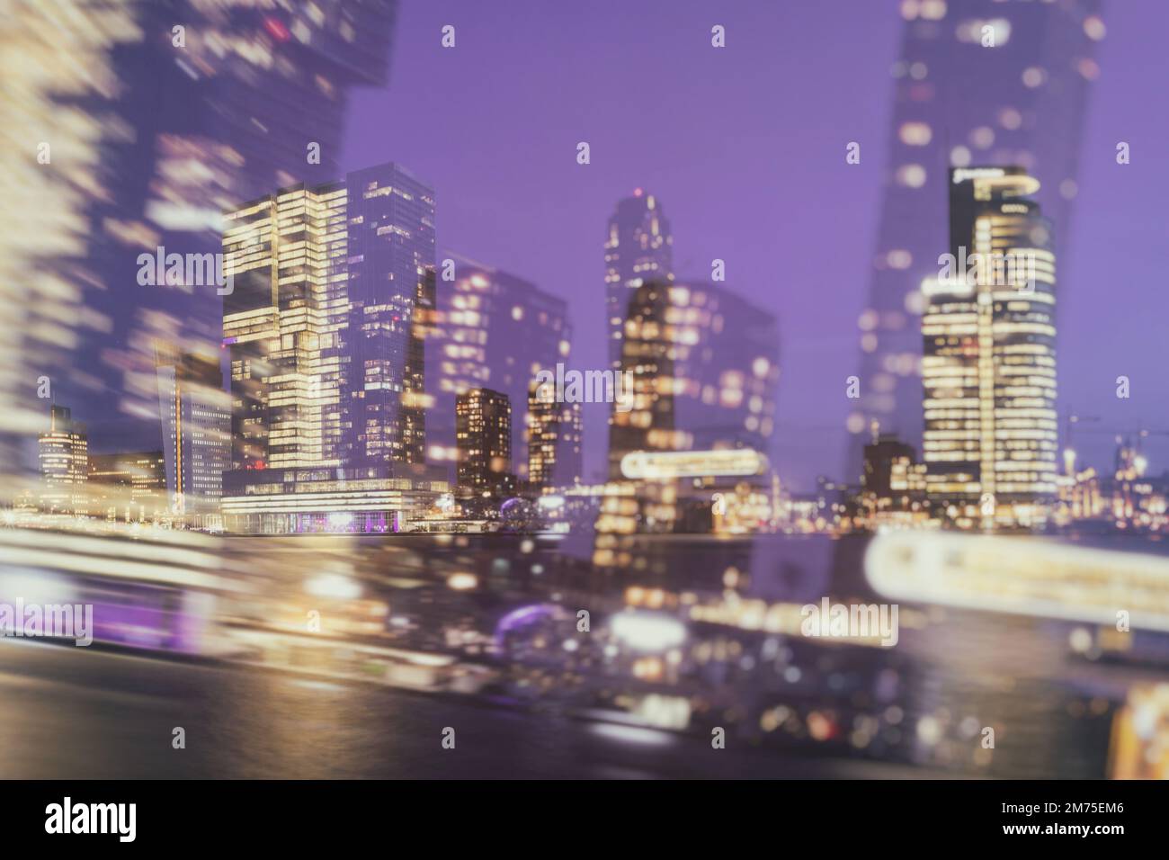 Urban nightly abstract background of skyscrapers with evening lights in ...