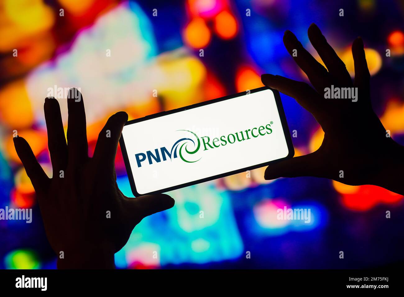 In this photo illustration, the PNM Resources logo is displayed on a ...