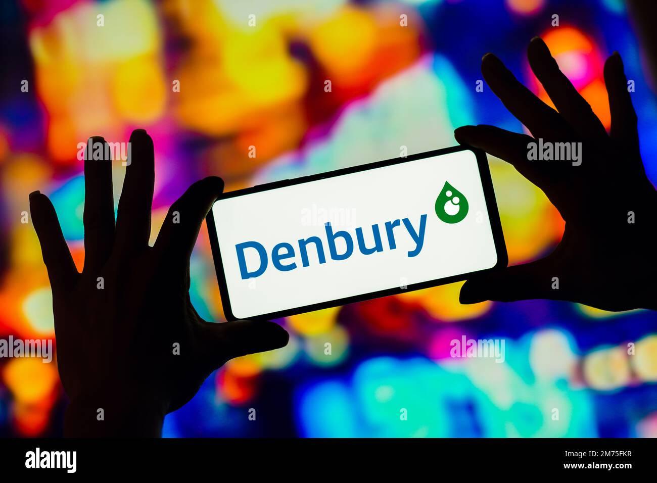 In this photo illustration, the Denbury Inc. logo is displayed on a smartphone screen Stock ...