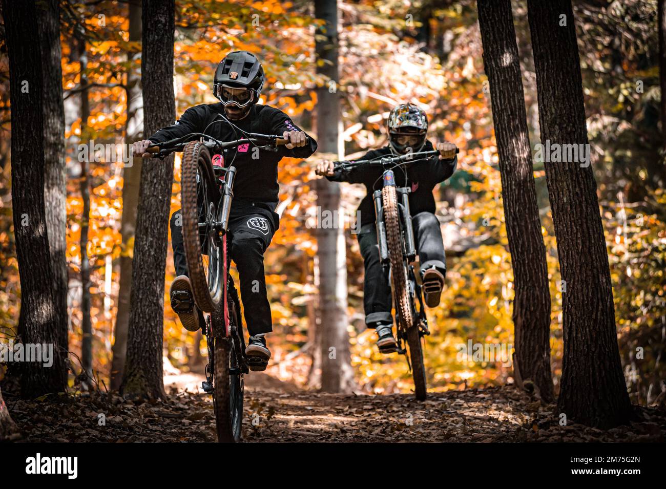 A horizontal shot of two riders ripping around a local park while ...