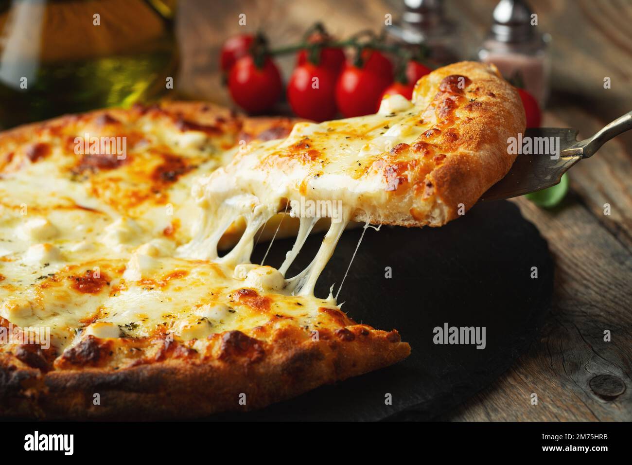A slice of hot Italian pizza with stretching cheese. Pizza four cheeses ...