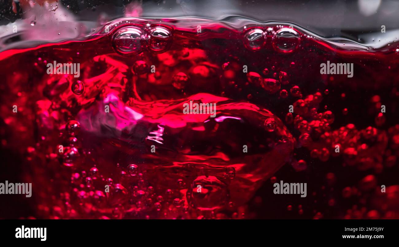 Red wine on a black background, abstract splashing Stock Photo - Alamy