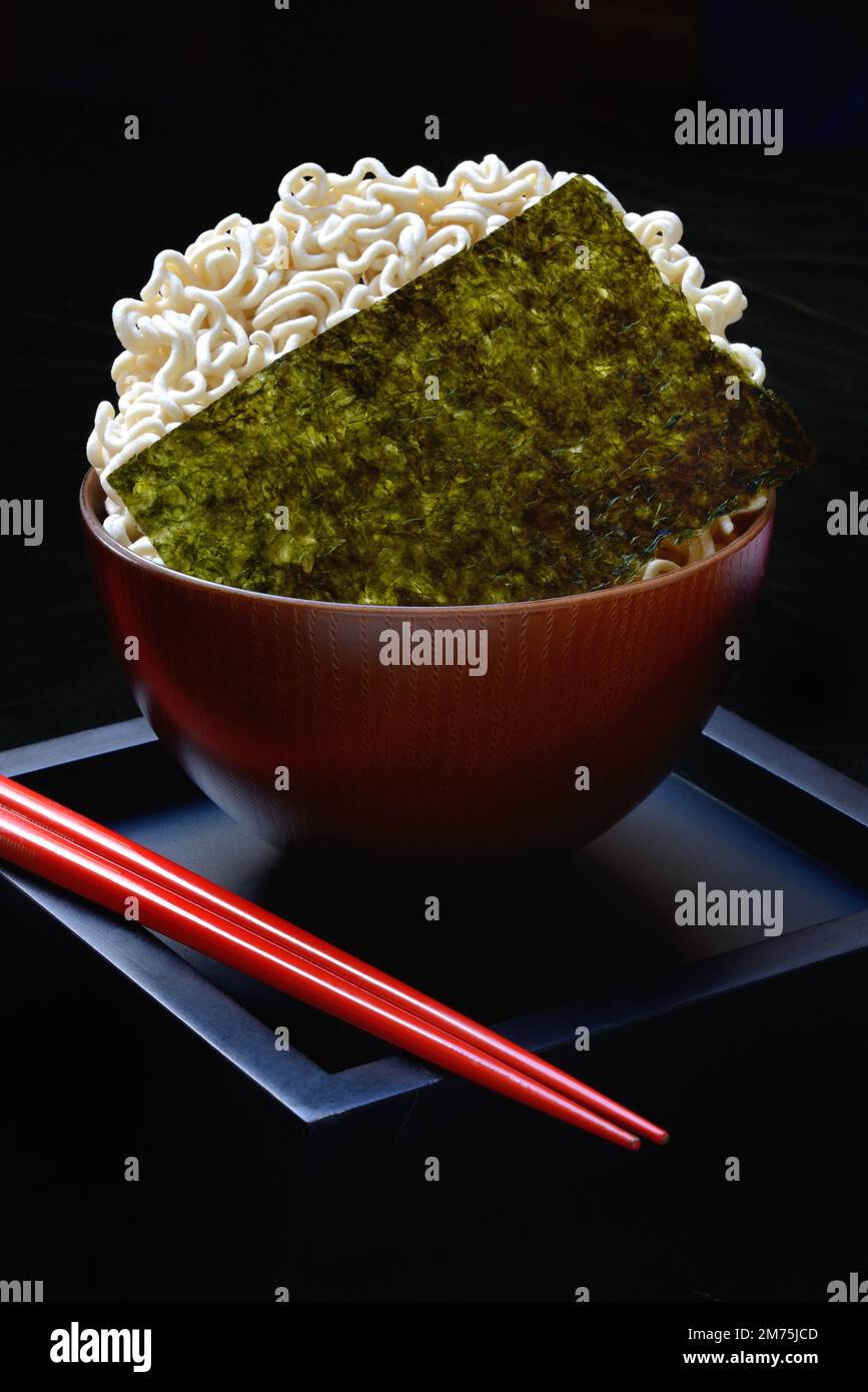 Nori, dried paper-like sheet of seaweed and Asian noodles in a shell ...