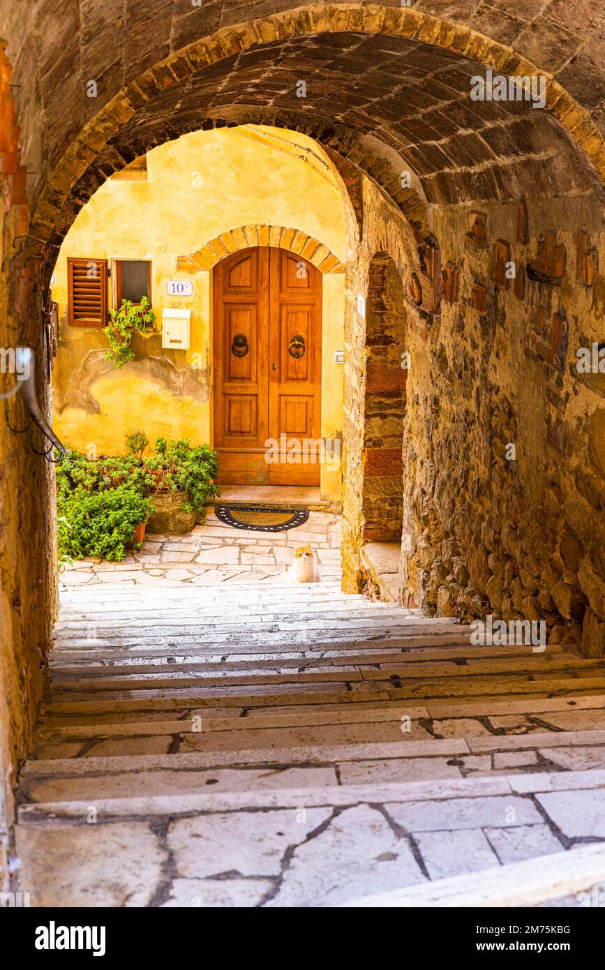Arched passageway with view of a house entrance door, Petroio, Tuscany ...