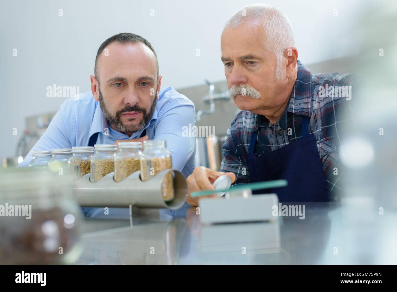 two men looking at samples in quality control laboratory Stock Photo ...