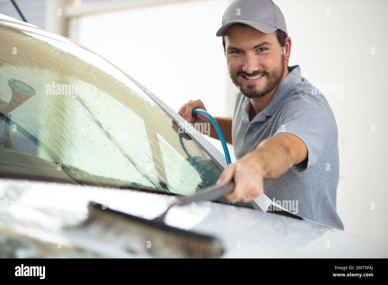 happy man is cleaning an automobile Stock Photo - Alamy